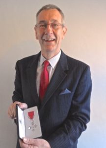 Dr Stephen Battersby collects MBE | Pest Magazine